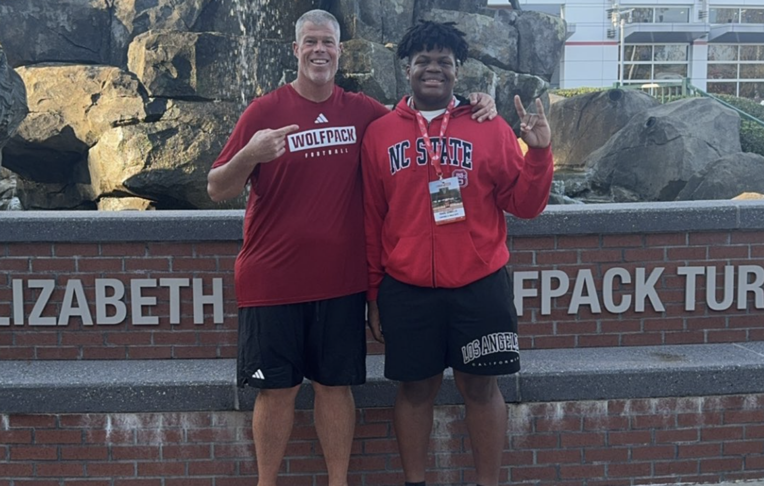 WATCH: NC State Offensive Line Coach Tujague Gets in the Wolfpack Statue